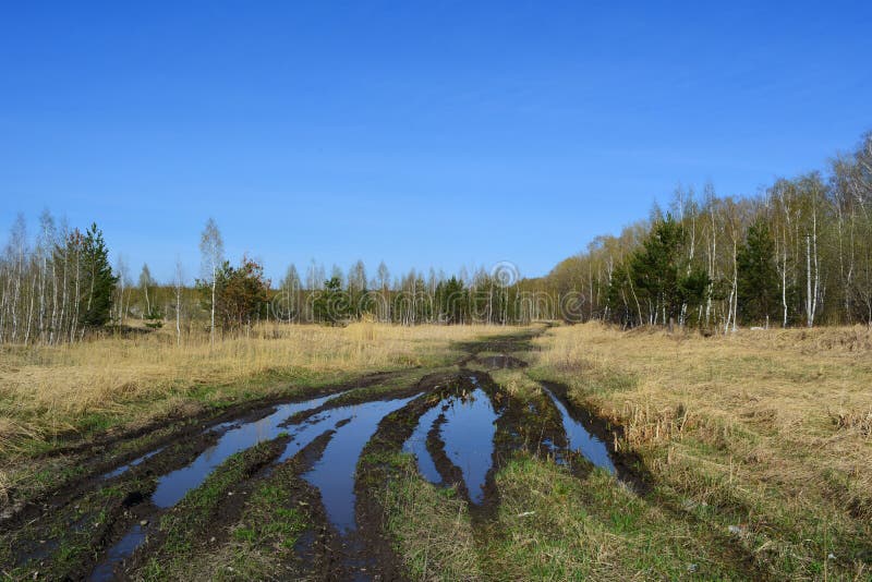 Spring Countryside Landscape with Puddle on Muddy Road Stock Photo ...