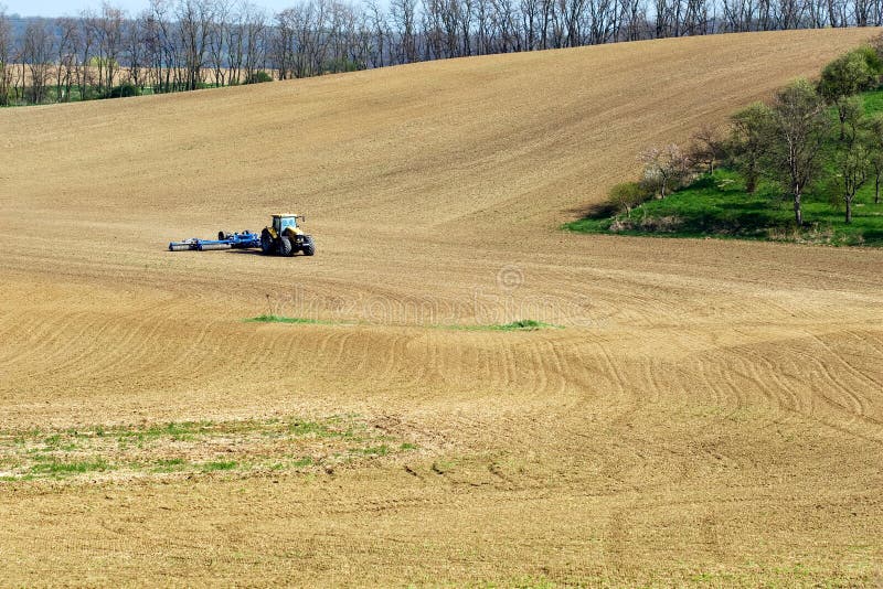 Spring Farmland with Tractor Stock Image - Image of village, flower ...