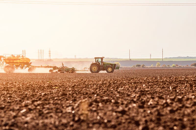 Spring Field Work. Tractor Plows the Ground in the Field. Plowed Soil ...