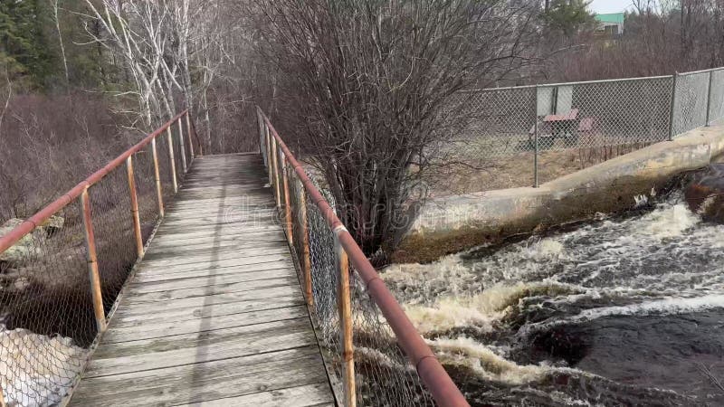 Spring Flood, Water Flows Under a Pedestrian Bridge Over a River Stock ...