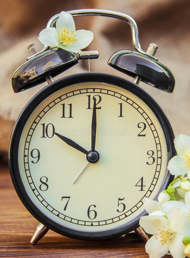 Spring Flowers and Alarm Clock. Change the Time Stock Image - Image of ...