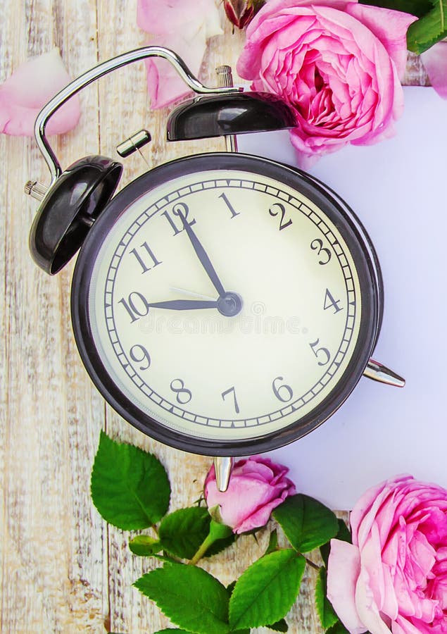 Spring Flowers and Alarm Clock. Change the Time Stock Image - Image of ...