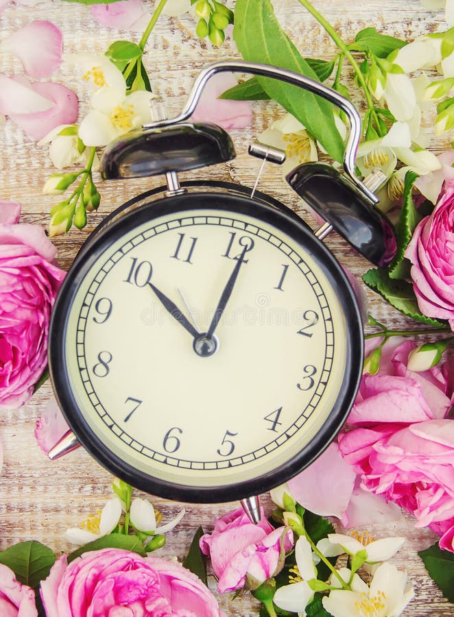 Spring Flowers and Alarm Clock. Change the Time Stock Image - Image of ...