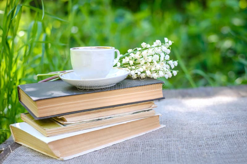 Spring Flowers Lilies Of The Valley And A Cup Of Tea On A Stack Of Old ...