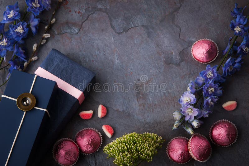 Spring Gift with Candy and Flowers on a Blue Stone Background Stock ...