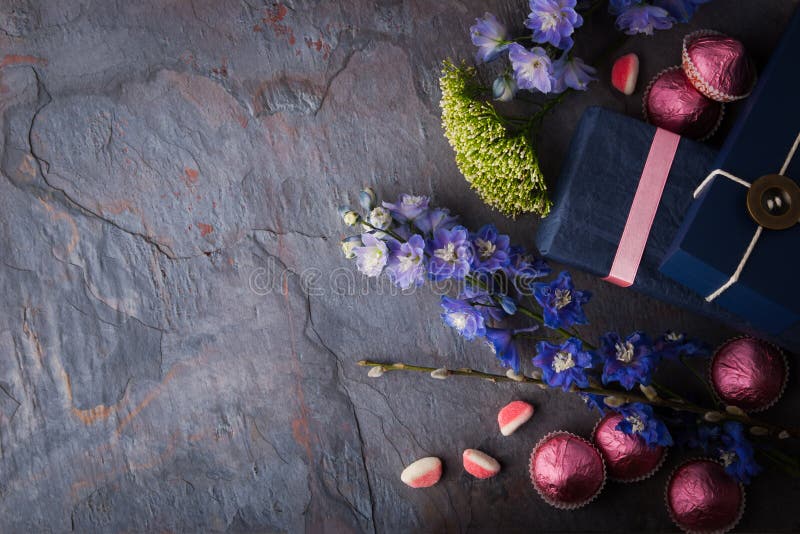 Spring Gift with Candy and Flowers on a Blue Stone Background Stock ...