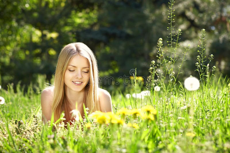 Spring Girl Lying on the Field of Dandelions Stock Photo - Image of ...