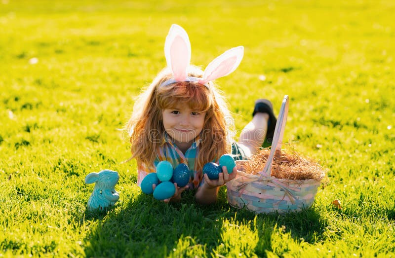 Spring Holiday. Kid Boy Lying on the Grass and Finding Easter Eggs ...