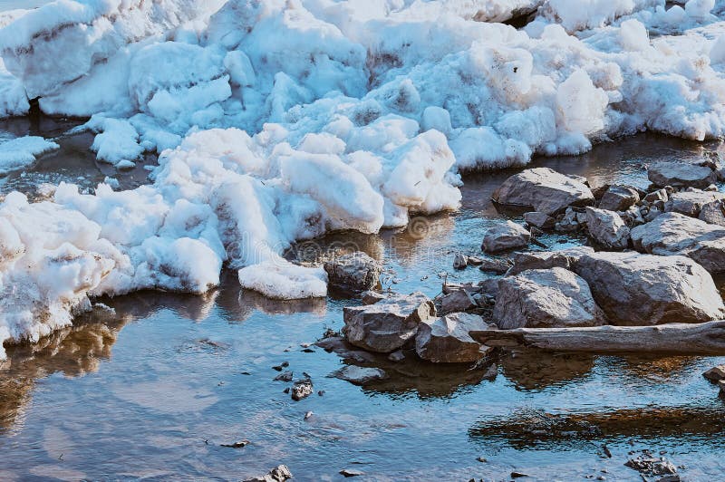 Spring Ice Drift on the River. Stones on the Coast. Melting Ice. Sunny ...