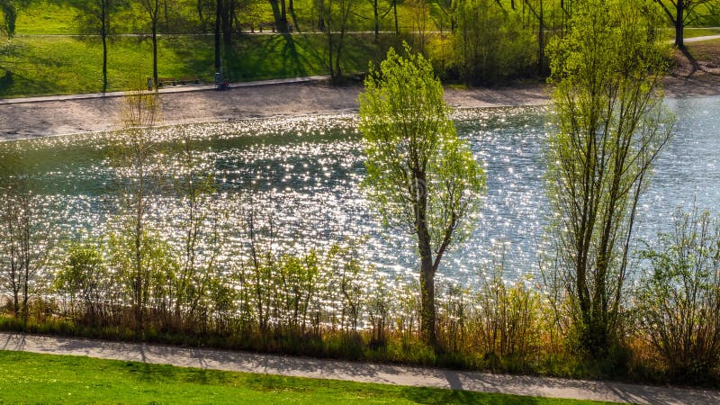 Spring Landscape at Lake with Flecks of Sunlight on Water Surface Stock ...