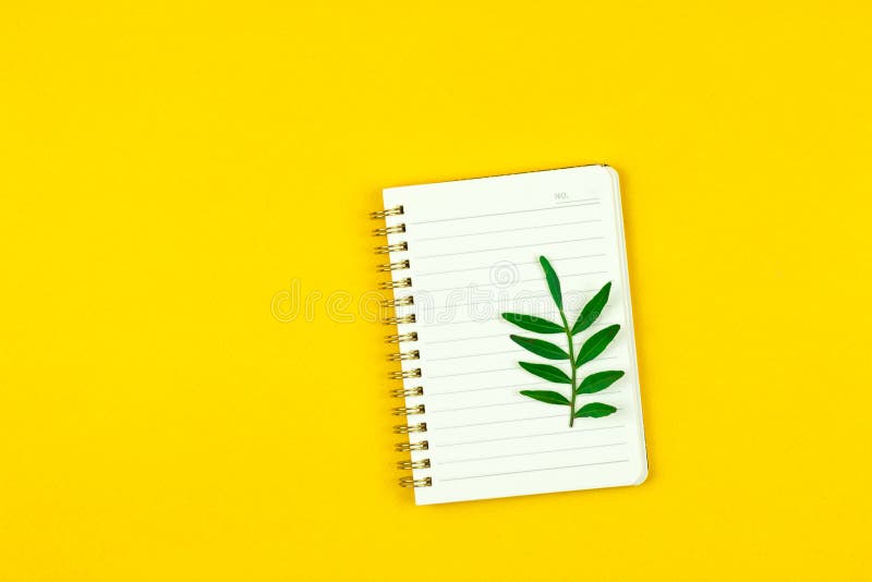 Spring Notepad Design or Mockup on Yellow Background with Green Leaves ...