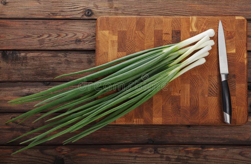 Spring Onions and Knife on Chopping Block Stock Photo - Image of food ...