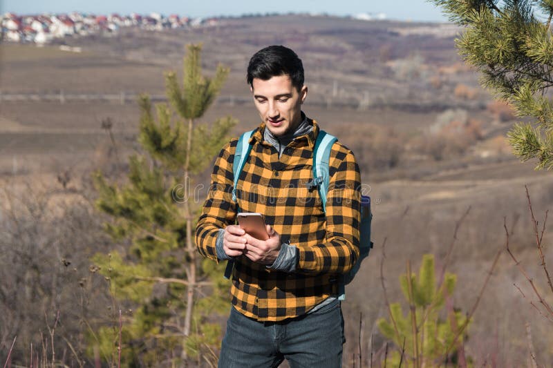 Spring Outdoors. Handsome Man in Countryside Using Phone To Navigate ...