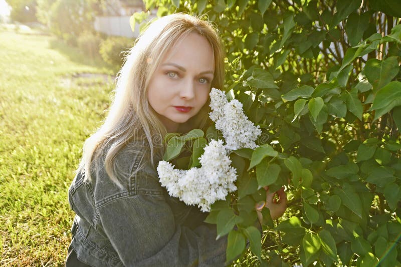 Spring Portraits of a Beautiful Woman Against a Background of Flowers ...