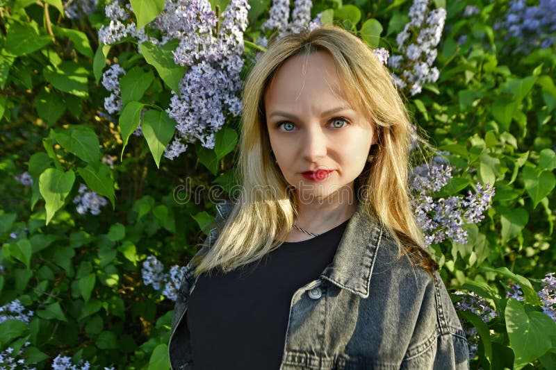 Spring Portraits of a Beautiful Woman Against a Background of Flowers. Stock Photo - Image of ...
