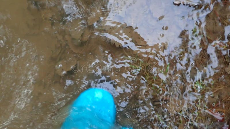 Spring Puddle.feet in Blue Rubber Boots in Spring Water.steps in the ...