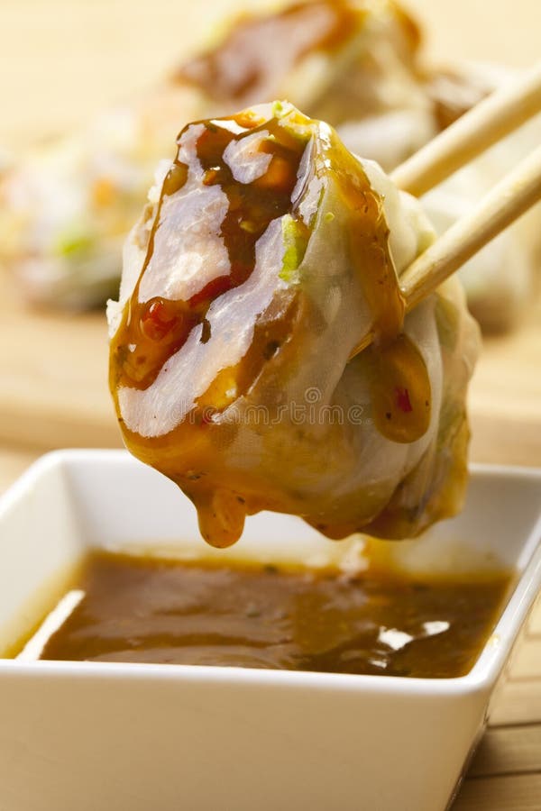 The Spring Roll Dipped in a Sauce Stock Photo - Image of diet, sauce ...