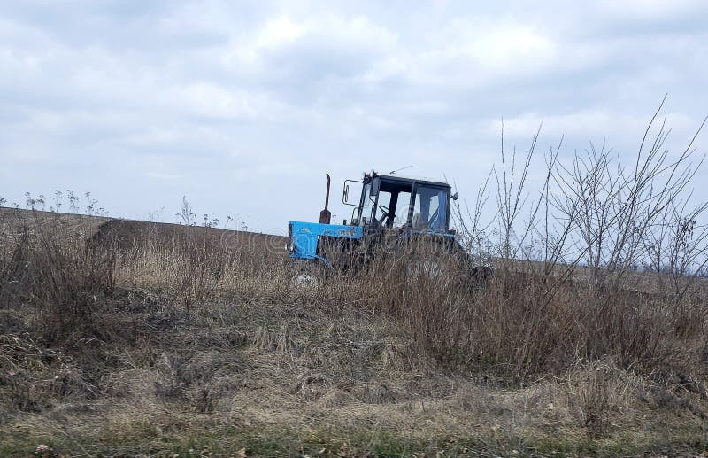 Tractor Works in the Field in Spring Stock Photo - Image of works, farm ...