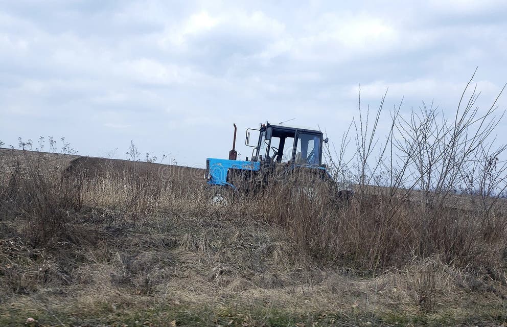 Tractor Works in the Field in Spring Stock Photo - Image of works, farm ...