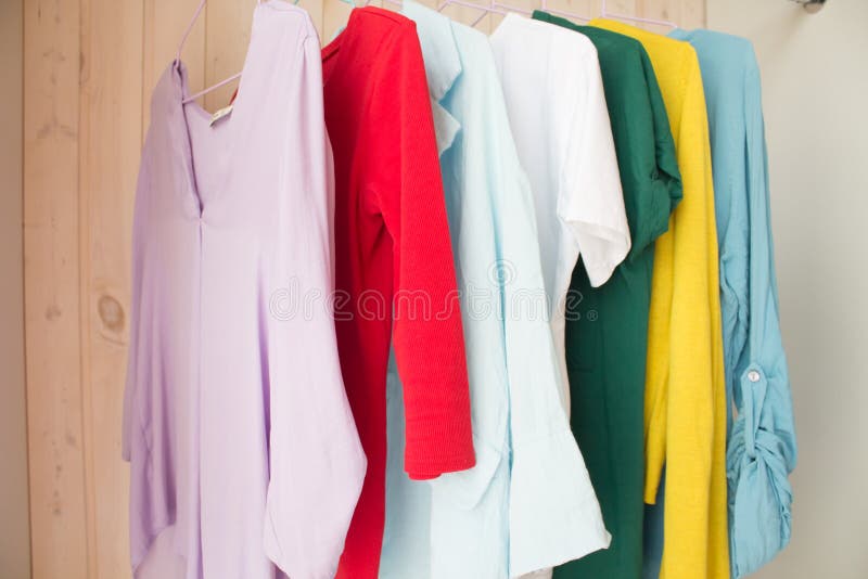 Spring-summer Wardrobe. Multi-colored Clothes on a Hanger in a Closet ...