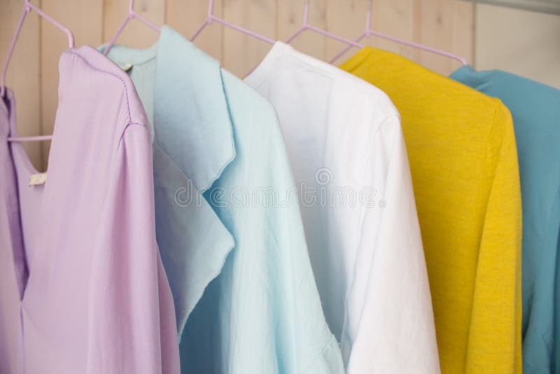 Spring-summer Wardrobe. Multi-colored Clothes on a Hanger in a Closet ...