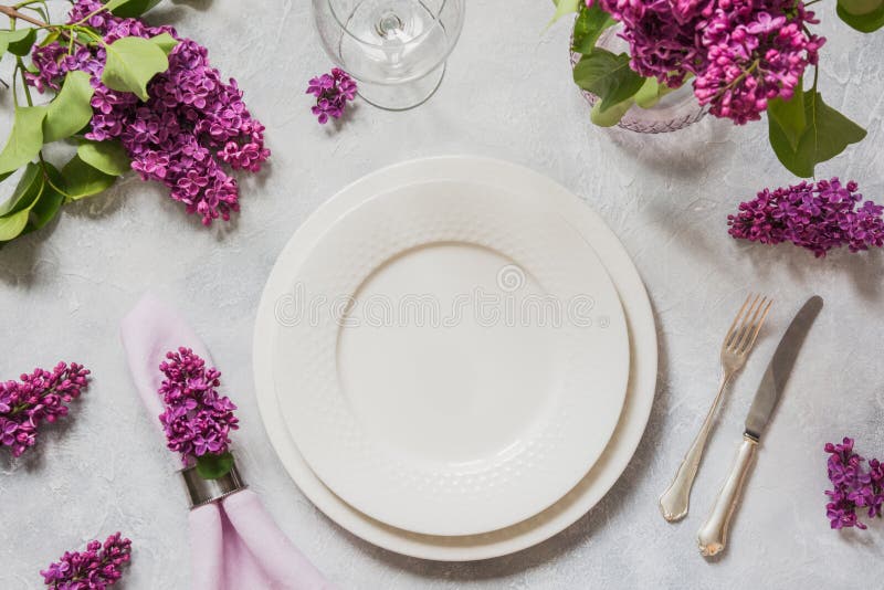 Spring Table Place Setting with Lilac Flowers, Silverware on Light ...