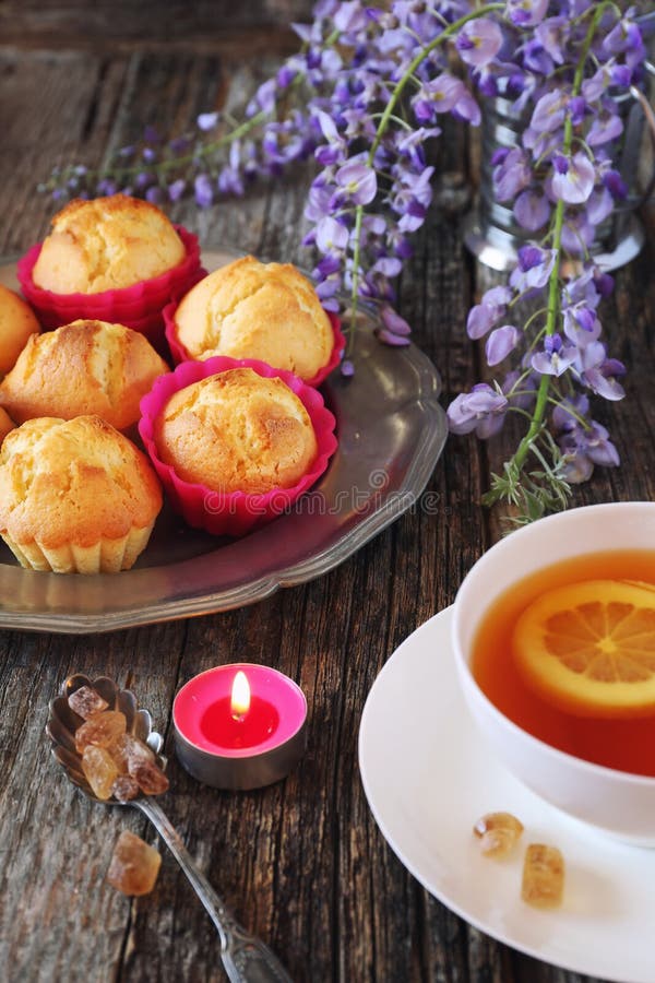 Spring Tea: Lemon Muffins, Tea and Flowering Wisteria Stock Photo ...