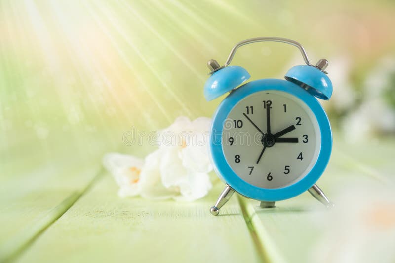 Spring Time Daylight Saving Concept - with Alarm Clock and Flowers ...