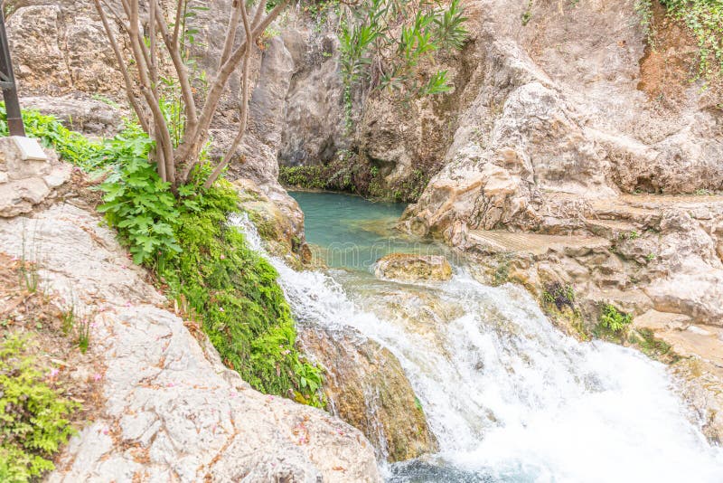Spring Water Falling between a Large Rocky Area Stock Image - Image of ...