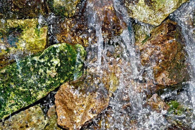 Spring water on rocks stock photo. Image of reflection - 310494044