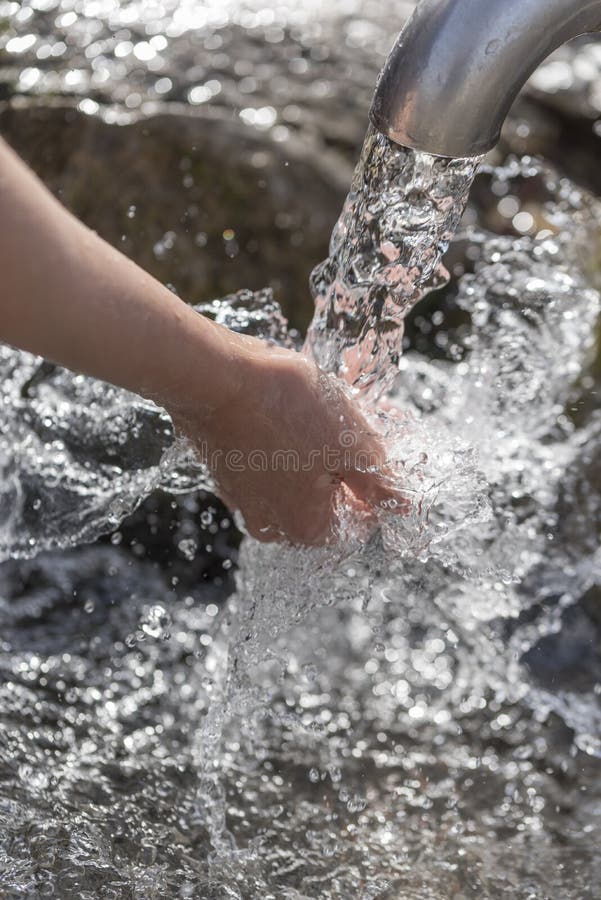 Spring Drinking Water Stream Pouring from Pipe on Hand Stock Image ...