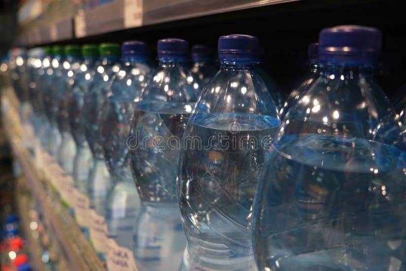 Spring Water on a Supermarket Shelf in Plastic Bottles. Closeup ...