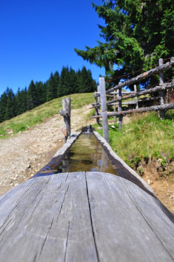 Spring Water in Wooden Well in the Alps Stock Photo - Image of ...