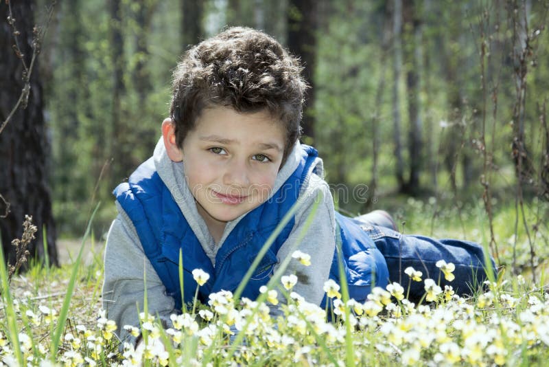 Spring in the Woods in the Meadow Lying a Happy Boy. Stock Image ...