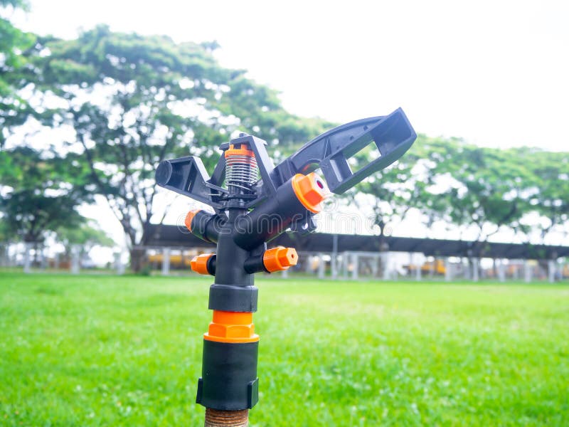 Springer is Doing Watering Plants and Lawns in the Garden Stock Photo ...