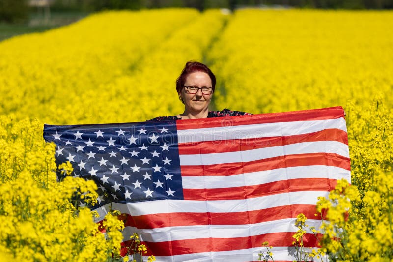 Springtime Patriotism: US Flag in a Rapeseed Field Stock Photo - Image ...