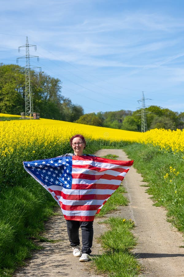 Springtime Patriotism: US Flag in a Rapeseed Field Stock Image - Image ...