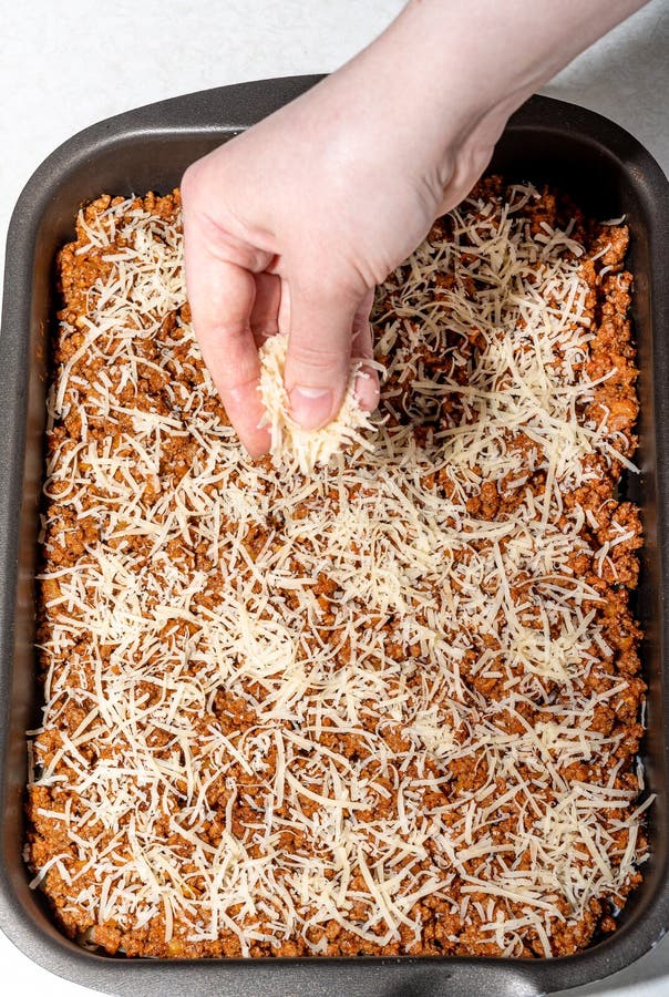 Sprinkle the Grated Cheese on a Layer of Minced Meat with Tomato Paste ...