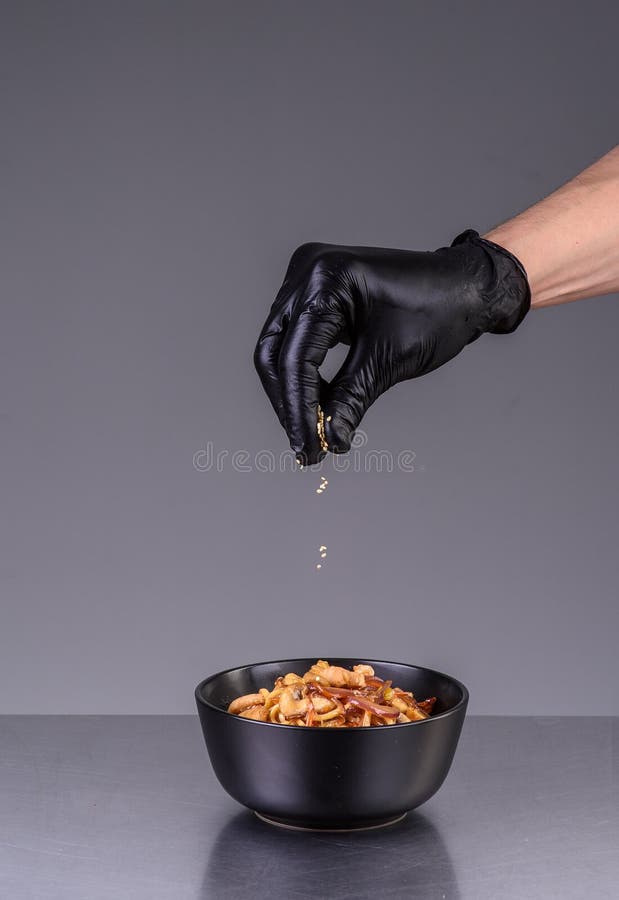 Sprinkle with Sesame Seeds Freshly Cooked Noodles in the Kitchen in a ...