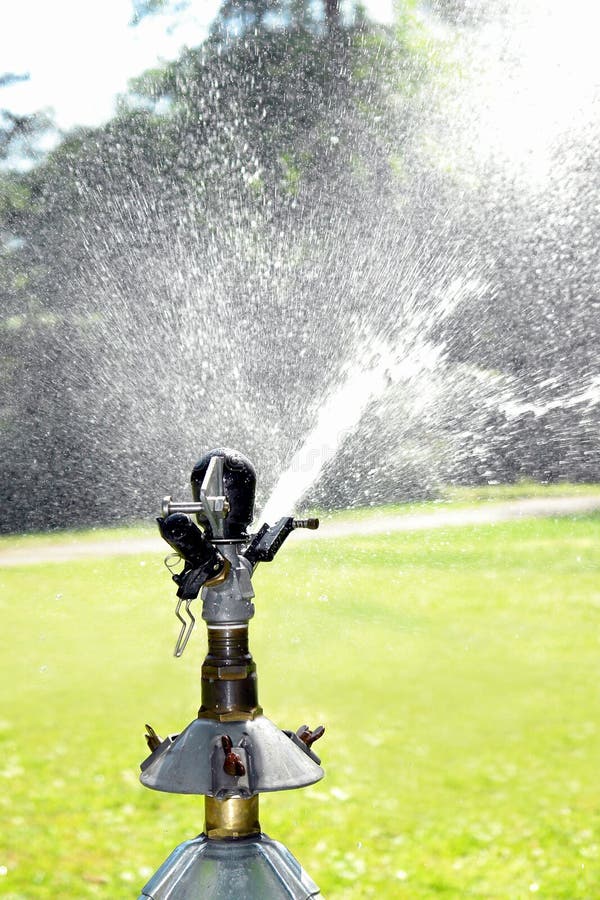 Sprinkler head spraying stock image. Image of sprinkler - 5480917