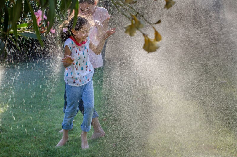 Sprinkler fun stock image. Image of cool, water, sprinkler - 61796669