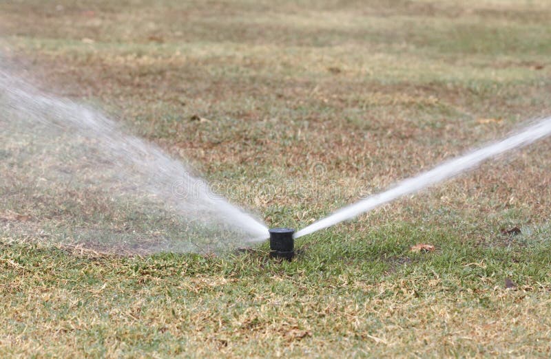 Sprinkler on a golf course stock image. Image of splash - 32784853