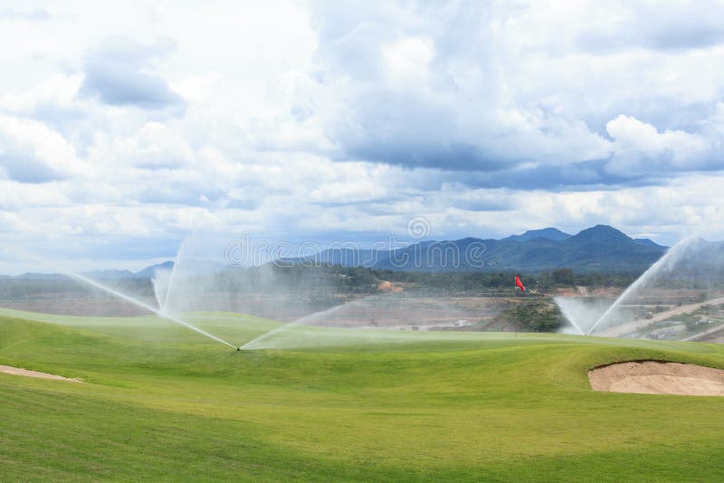 Sprinklers on golf course stock photo. Image of lush - 32362132