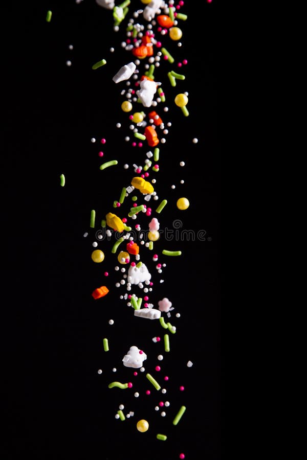 Sprinkles Falling on a Dark Background Stock Photo - Image of food ...