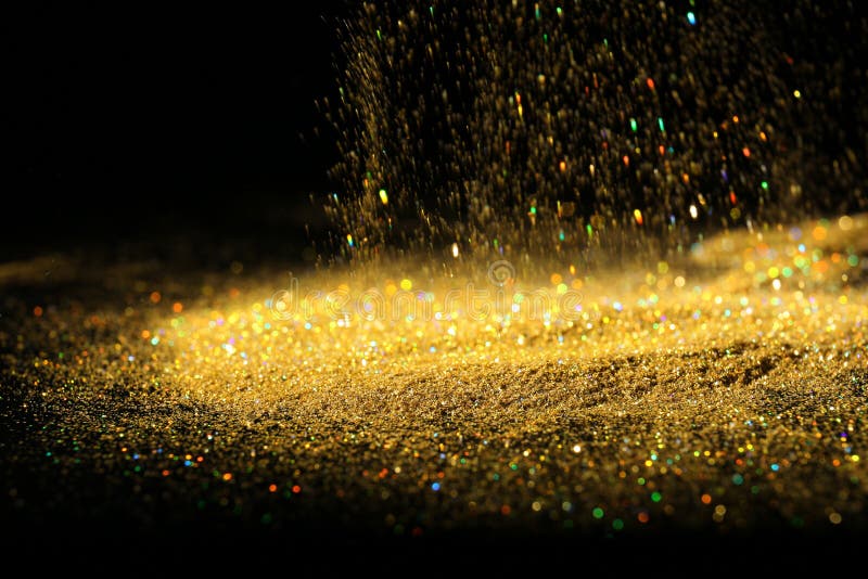 A Sprinkling of Golden Color Glitter on a Black Background Stock Photo ...