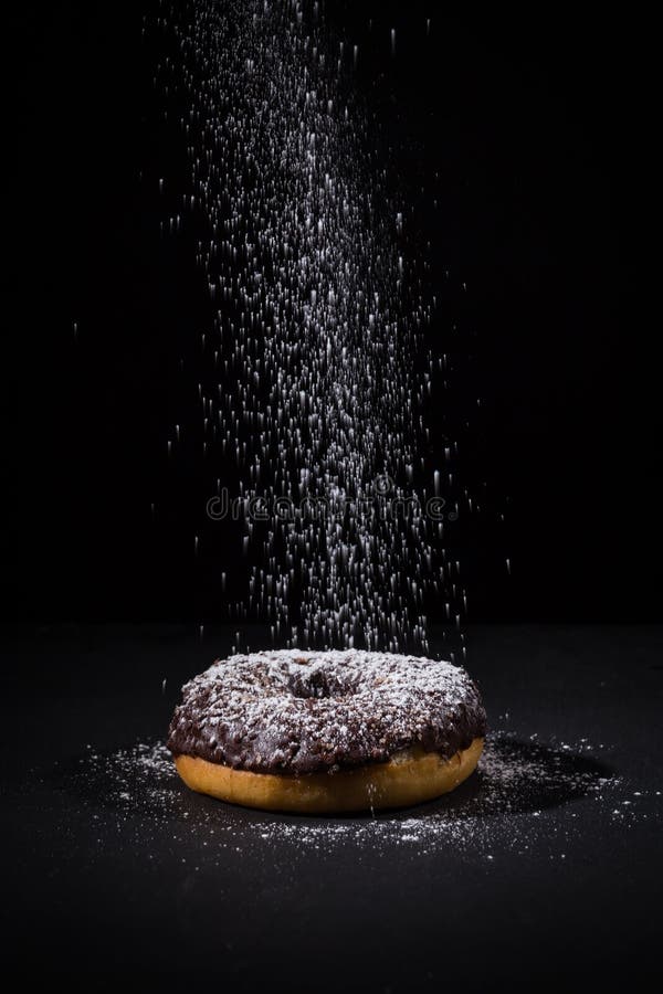 Sprinkling Sugar Powder on Chocolate Donut Stock Photo - Image of snow ...