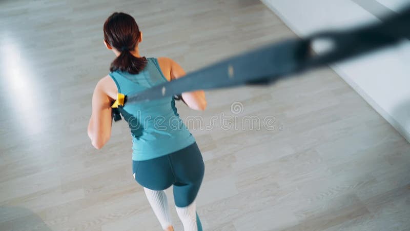 Sprinter. Inclined Running in Place with TRX Ribbons. TRX Exercise ...