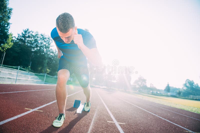 Sprinter Leaving Starting Blocks on the Running Track. Explosive Start ...