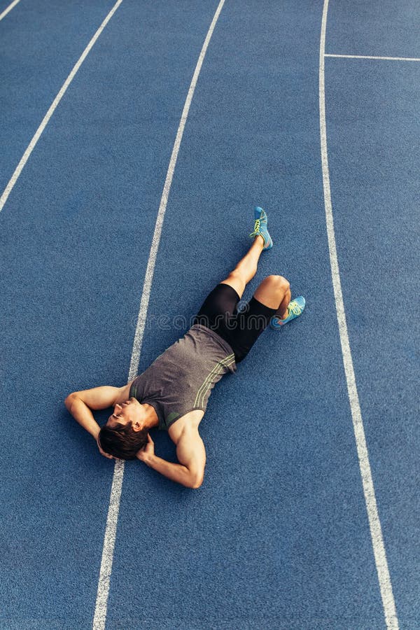 Sprinter Relaxing by Lying on the Running Track Stock Image - Image of ...