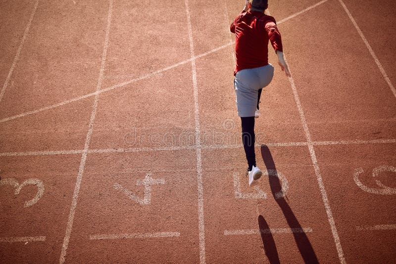 Sprinter Taking Off from Starting Block on Running Track Stock Photo ...